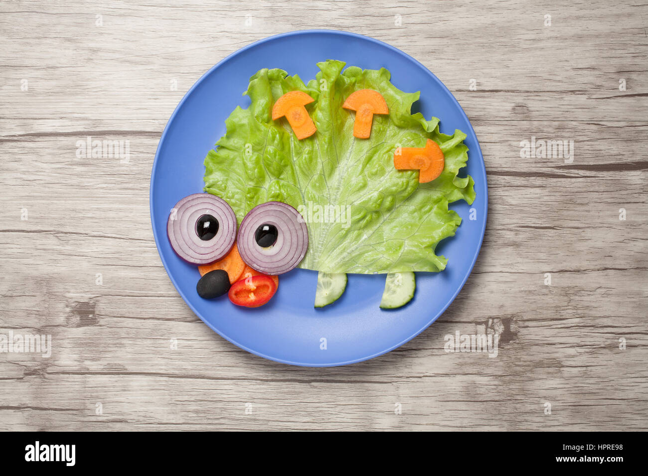 Hedgehog made of vegetables on plate and desk Stock Photo - Alamy