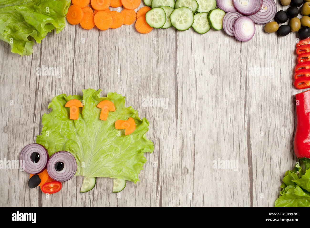 Hedgehog made of fresh vegetables on table with ingredients Stock Photo ...