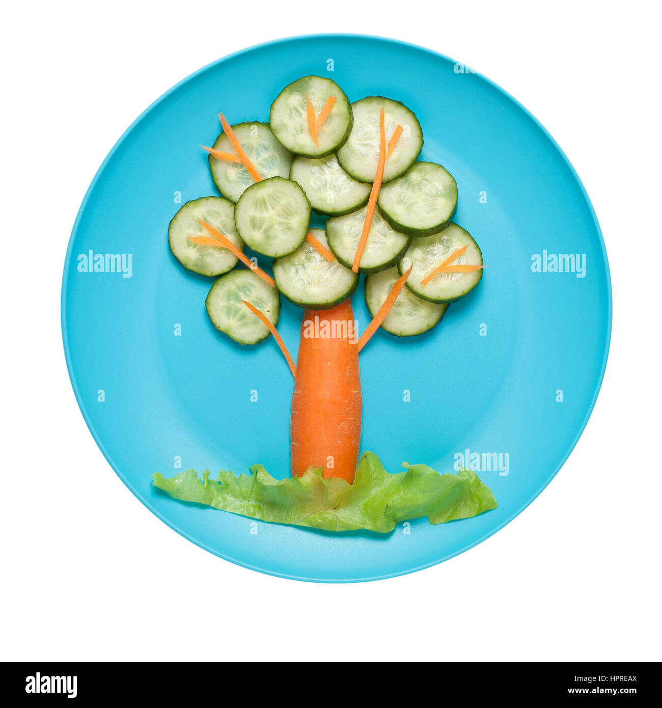 Tree made of cucumber and carrot on plate Stock Photo - Alamy