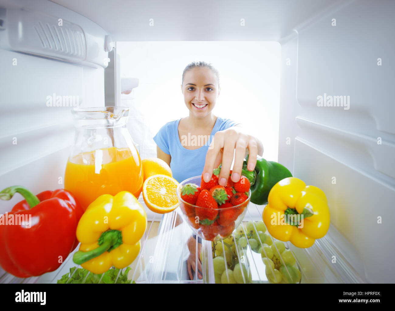 Woman reaching for food in refrigerator, view from inside Stock Photo ...