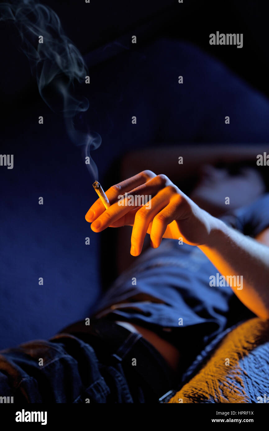 Close up of teenage boy smoking drugs, copy space Stock Photo - Alamy