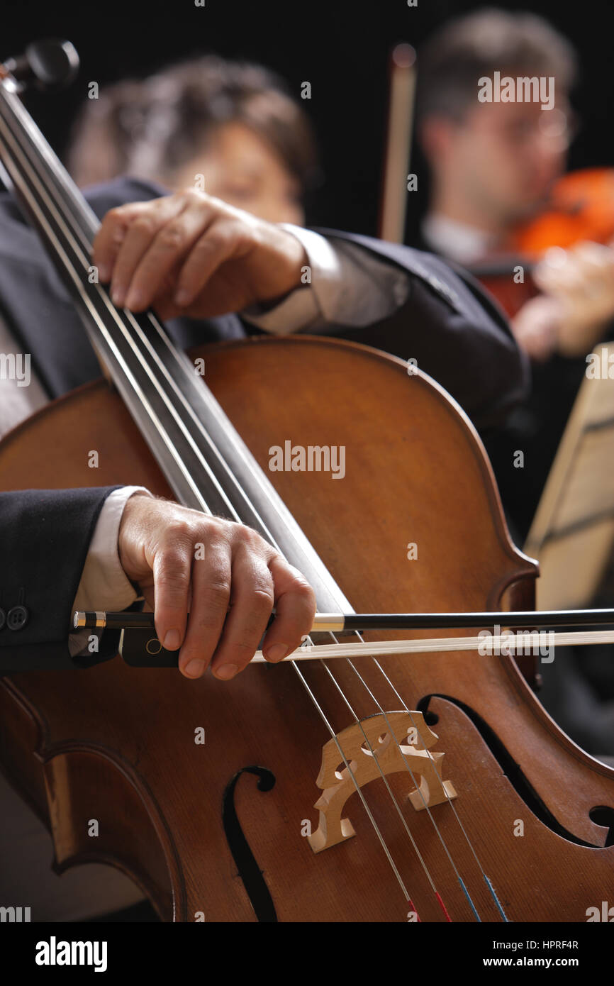 Symphony concert, a man playing the cello, hand close up Stock Photo ...