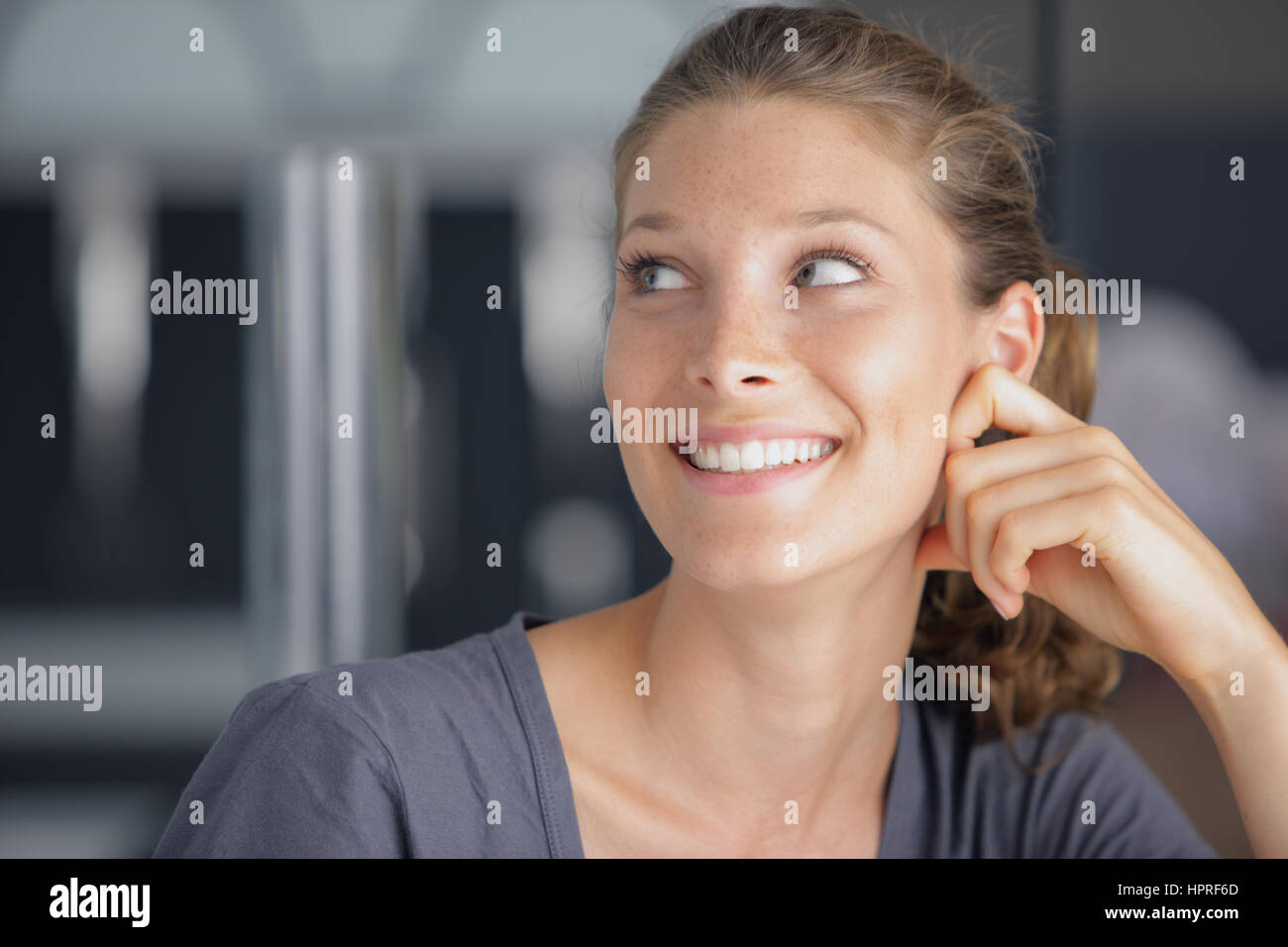 Portrait of a beautiful young woman, looking up into the corner on copy ...