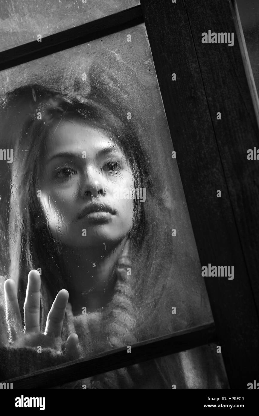 Portrait of a beautiful woman behind window, focus on rain drop Stock ...