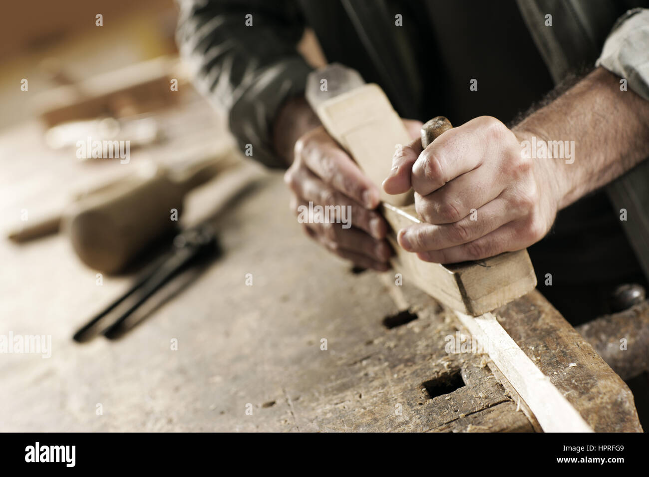 Hands of a carpenter planed wood, workplace Stock Photo - Alamy