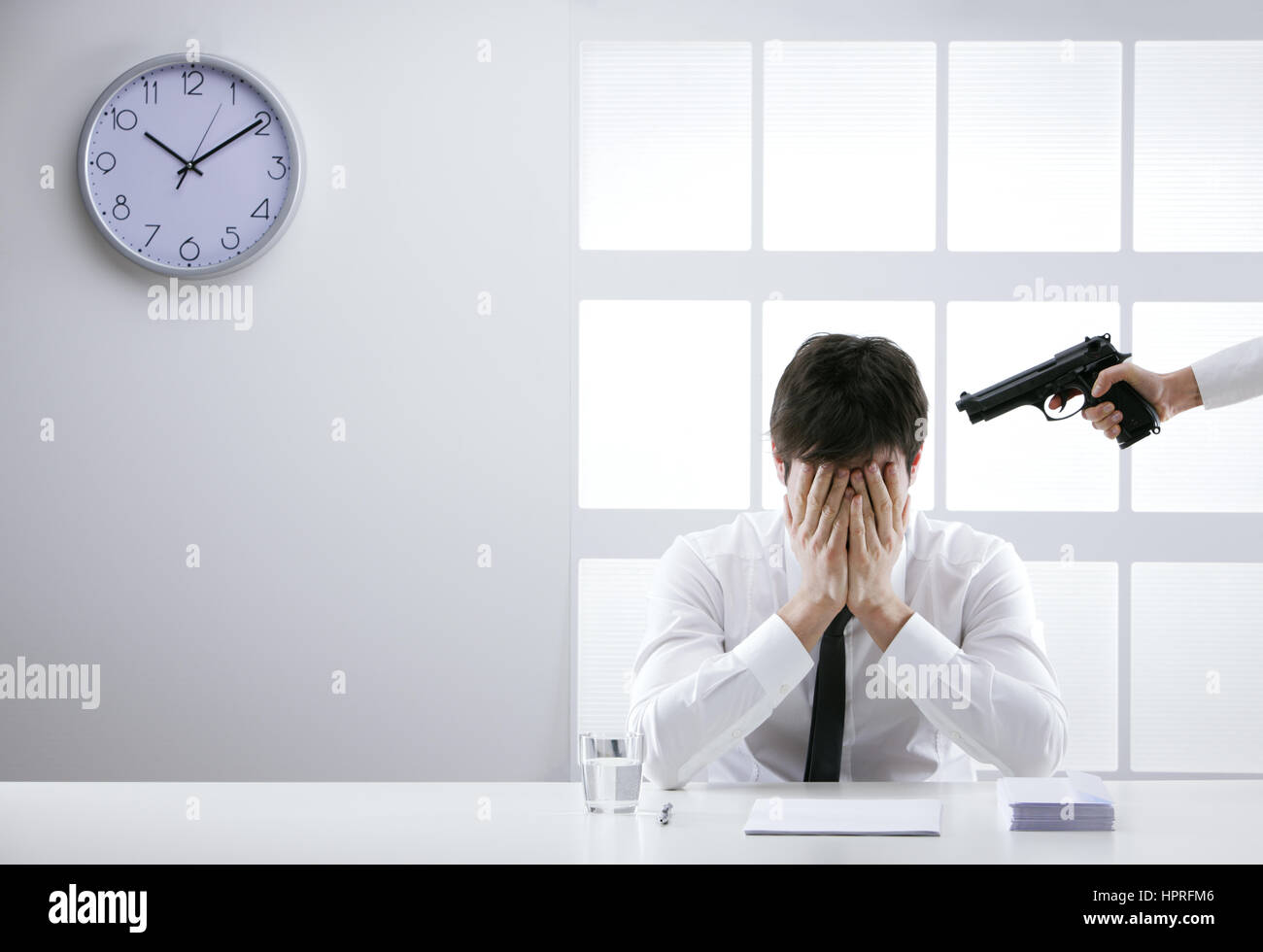 A young businessman threatened with gun Stock Photo - Alamy