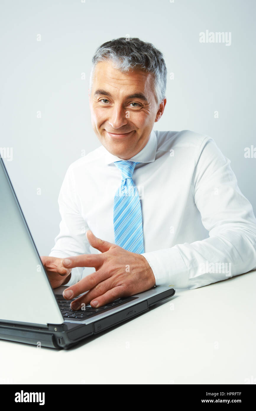 Carefree office worker working laptop hi-res stock photography and images - Alamy
