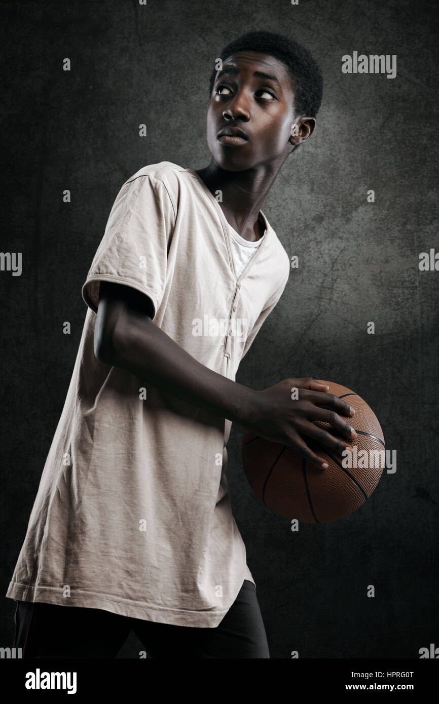 An African boy concentrating to shoot a basketball Stock Photo - Alamy