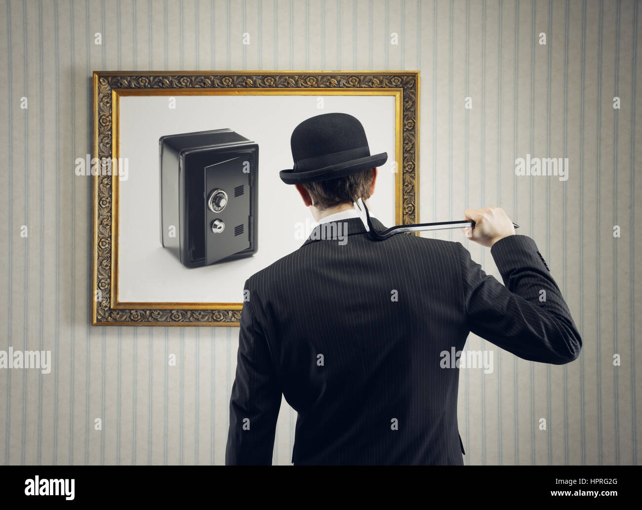 Thief with crowbar looks at a safe Stock Photo - Alamy