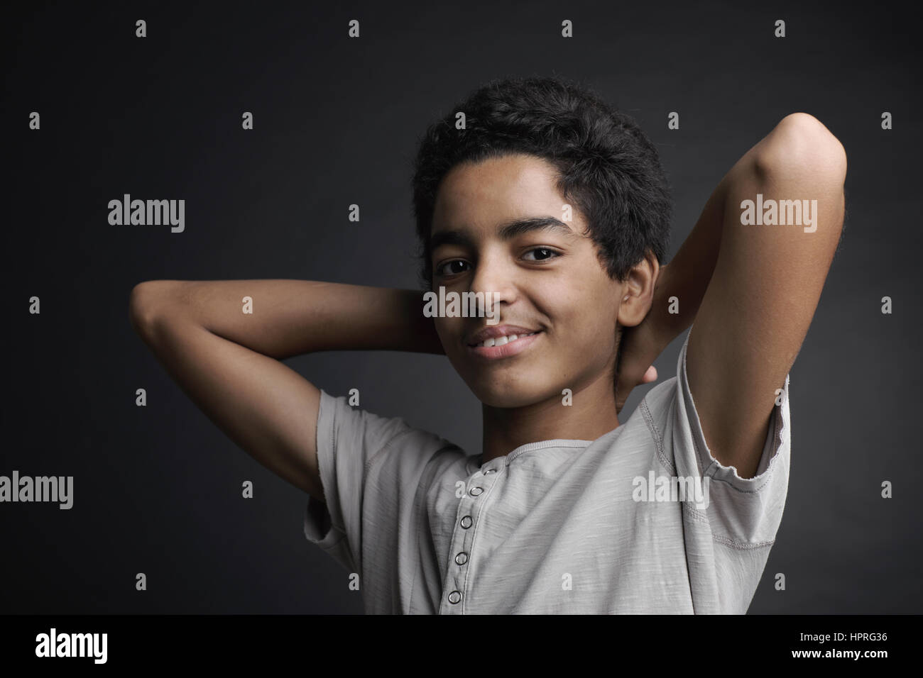 Portrait of cheerful african teenager on black background Stock Photo ...