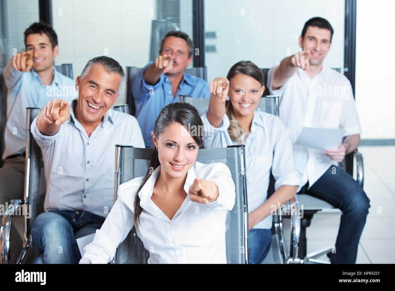 Portrait of a smiling business team pointing at you Stock Photo - Alamy