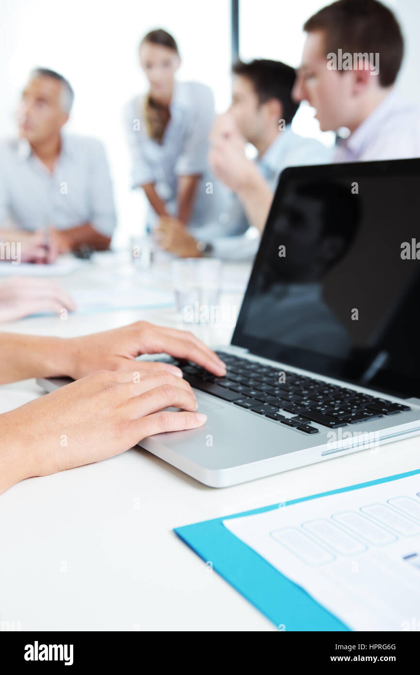 Group of business people working together, hands typing on laptop Stock ...