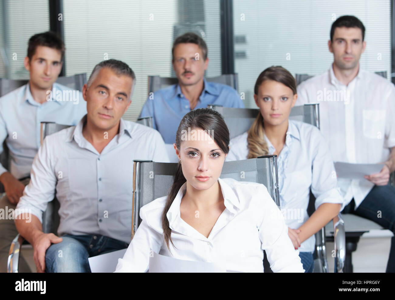 Portrait of a business team sitting together in the office Stock Photo ...
