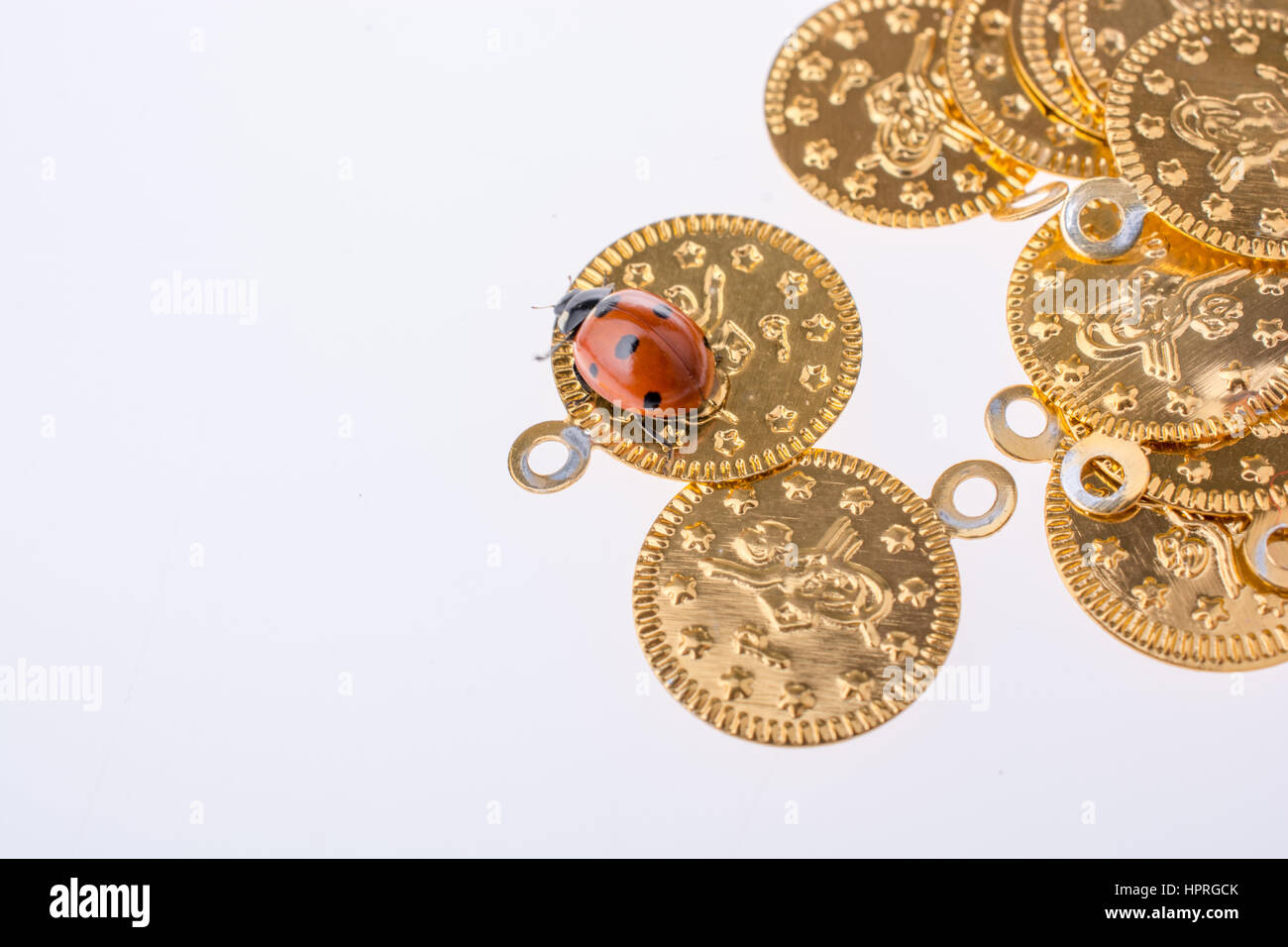 Beautiful photo of red ladybug walking on a fake coins Stock Photo - Alamy