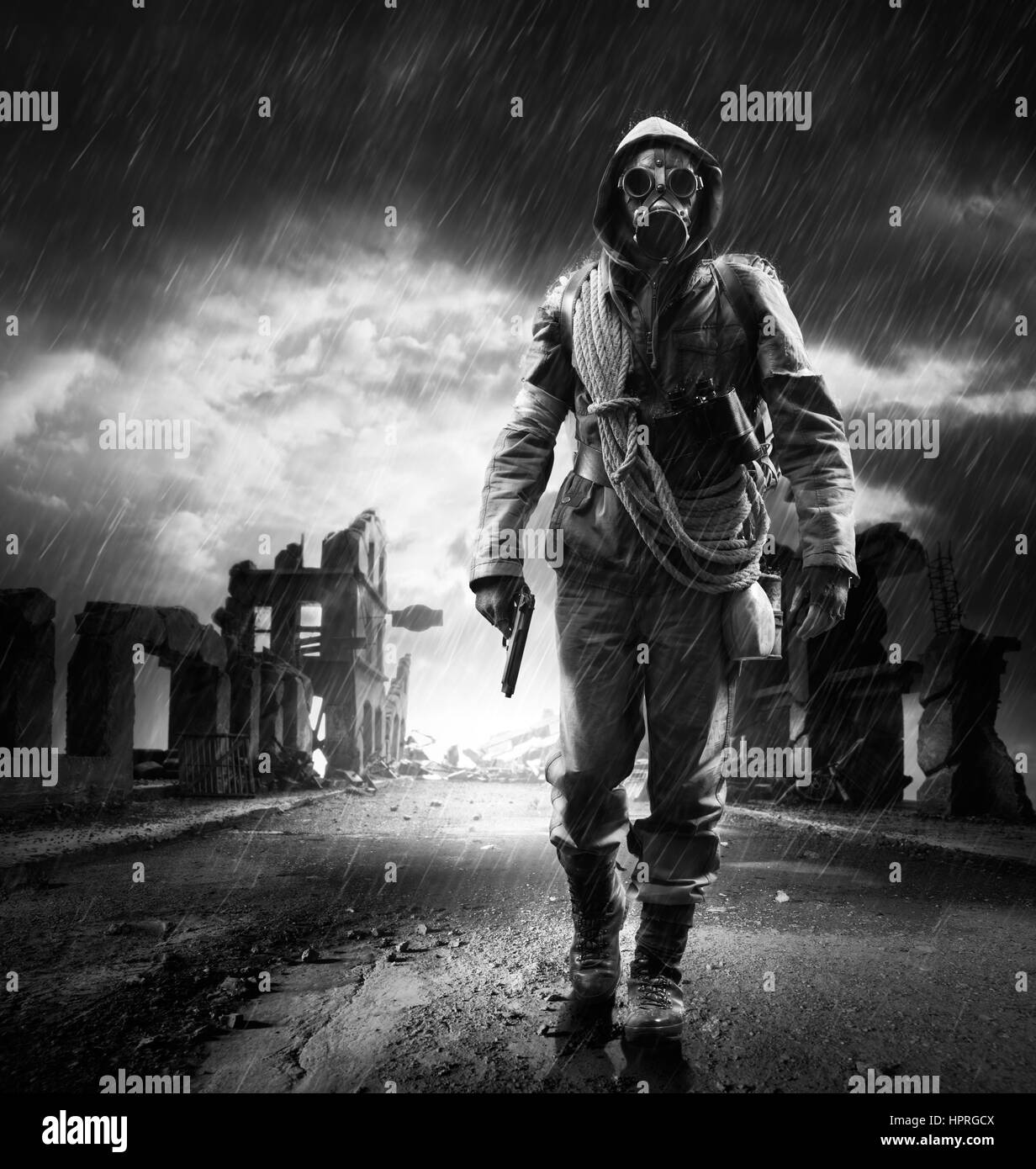 A lonely hero wearing gas mask walking through a city destroyed Stock ...