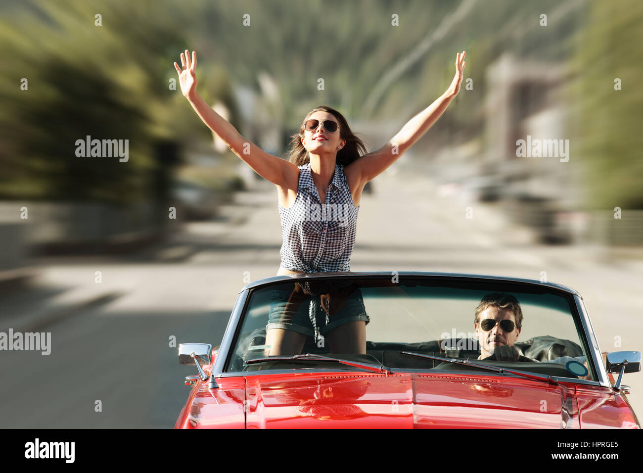 Happy young people in a convertible car Stock Photo - Alamy