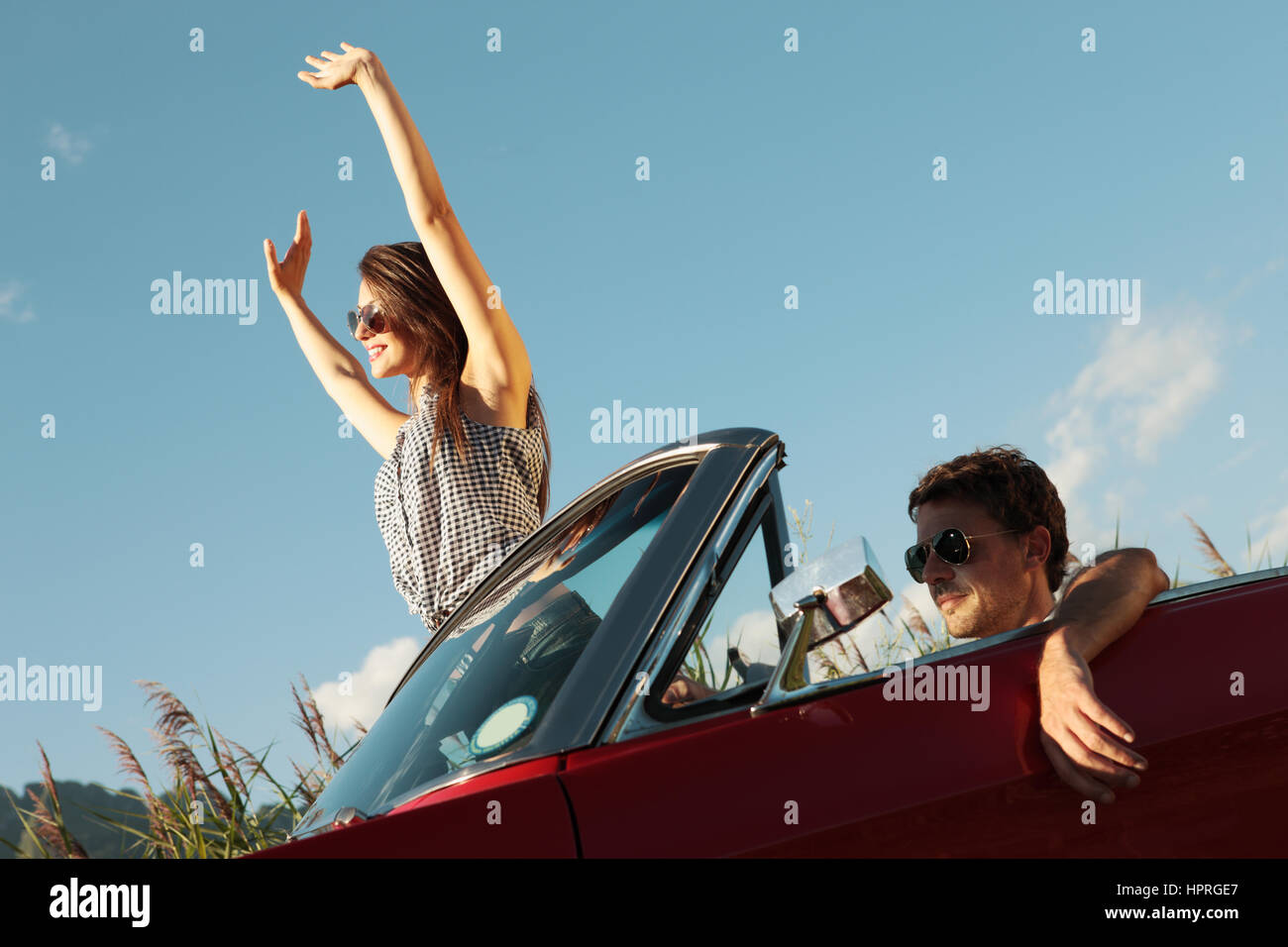 Happy young people in a convertible car Stock Photo - Alamy