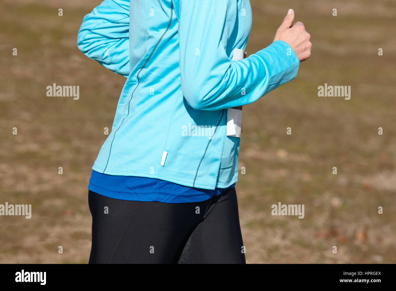Female athletic runner on a cross country race. Outdoor circuit ...