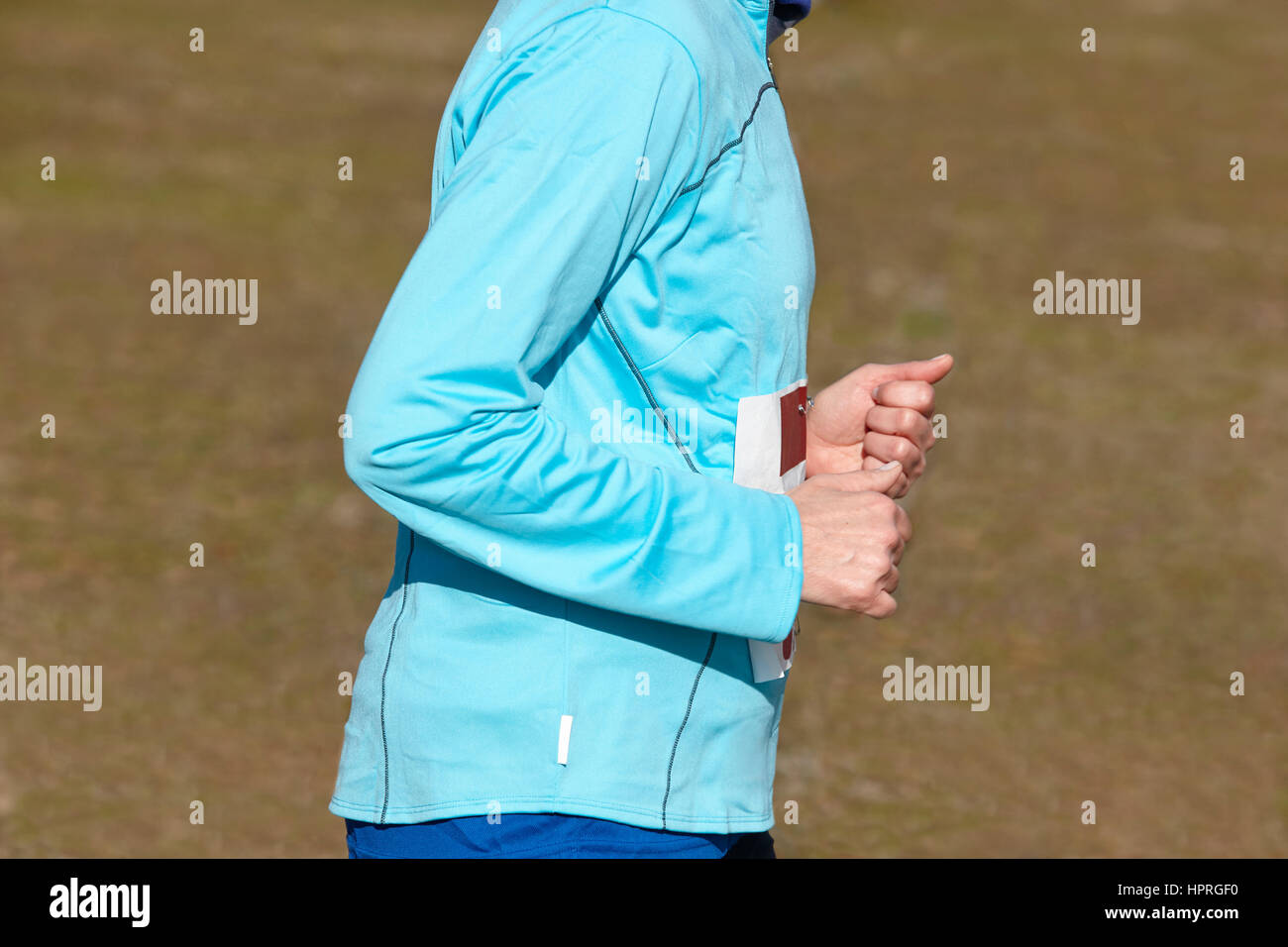 Female athletic runner on a cross country race. Outdoor circuit ...