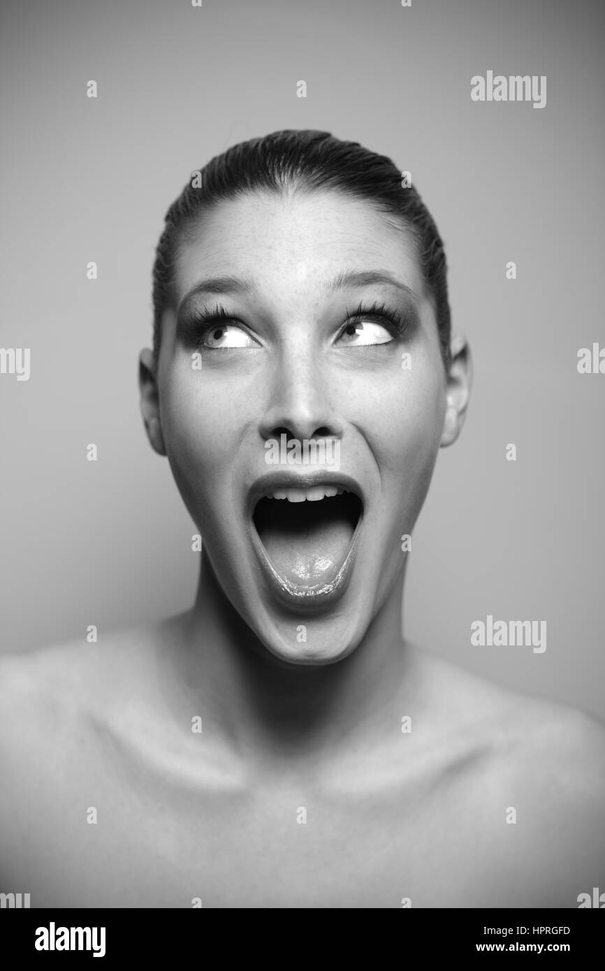 Portrait of beautiful surprised woman looking up Stock Photo - Alamy