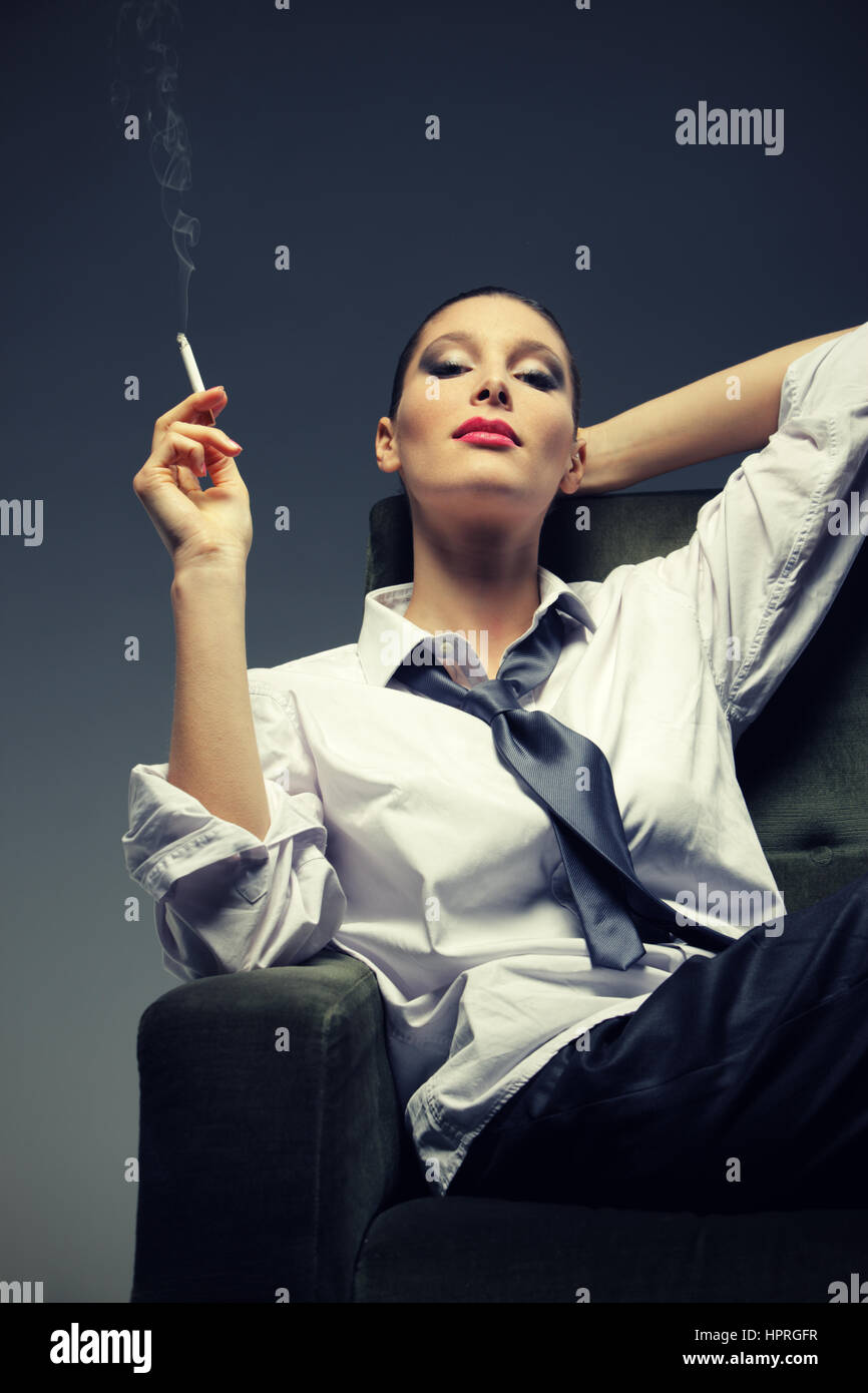 Sensual woman smoking a cigarette, fashion model portrait Stock Photo ...