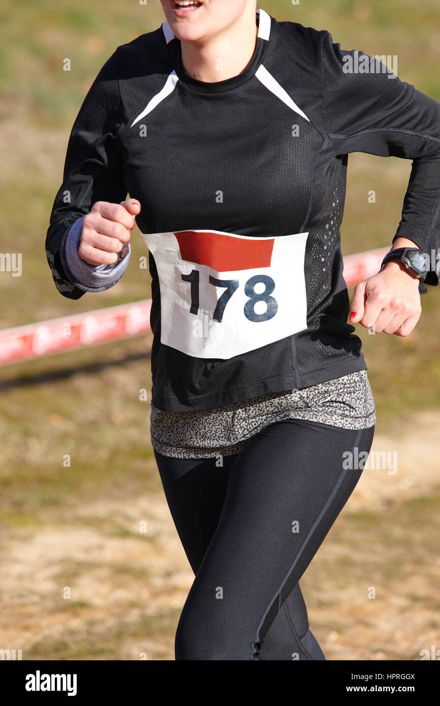 Female athletic runner on a race. Outdoor circuit. Vertical Stock Photo ...