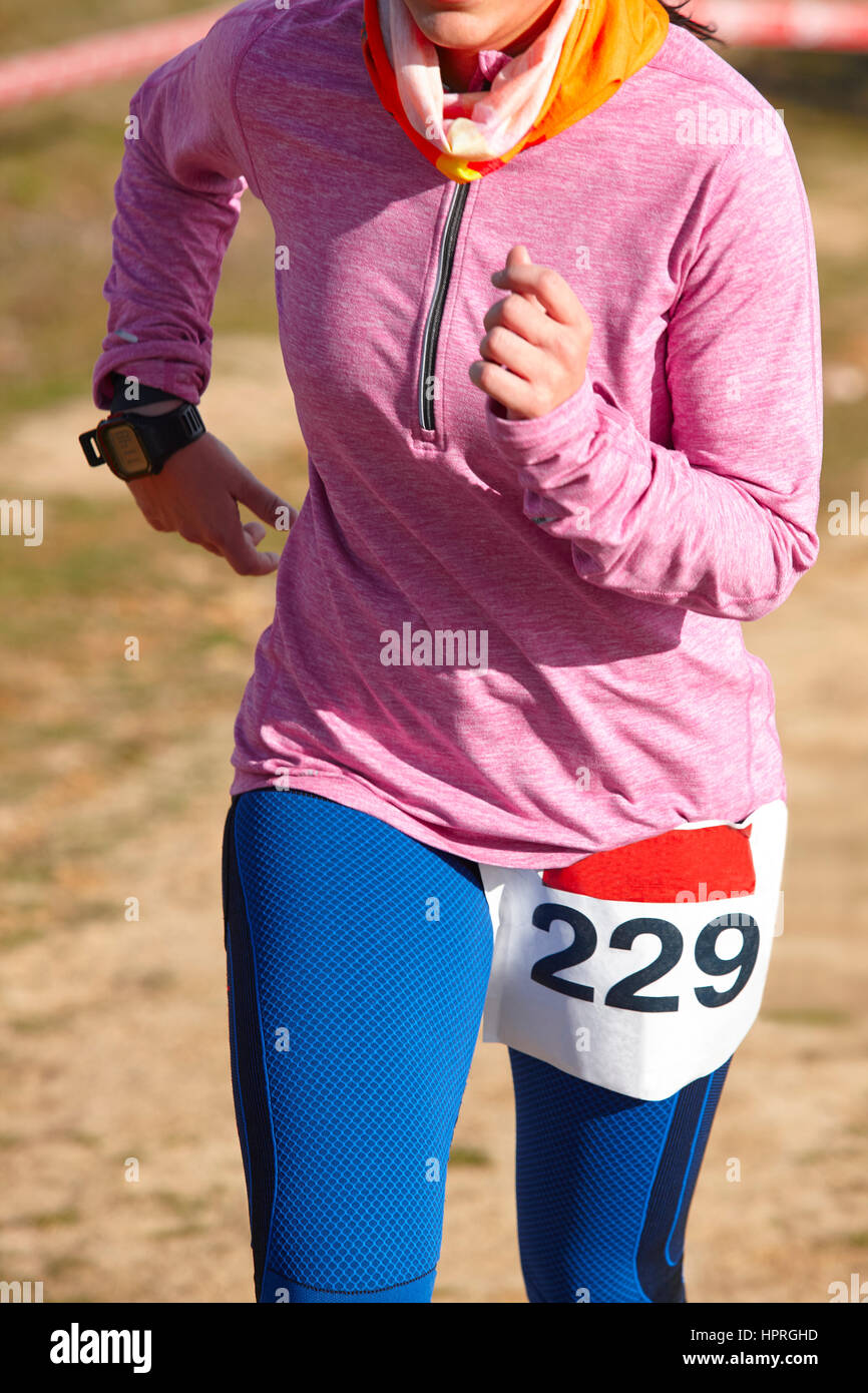 Female athletic runner on a race. Outdoor circuit. Vertical Stock Photo ...