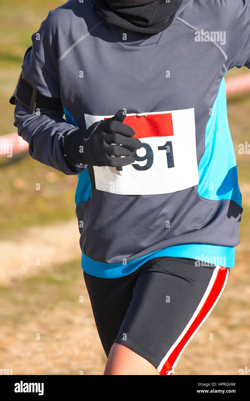 Male athletic runner on a cross country race. Outdoor circuit. Vertical ...