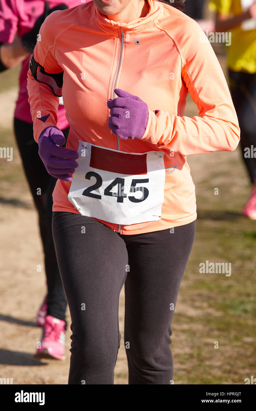 Female athletic runners on a cross country race. Outdoor circuit ...