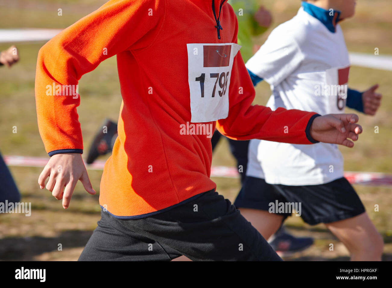 Young athletics runners on a race. Outdoor circuit. Horizontal Stock ...
