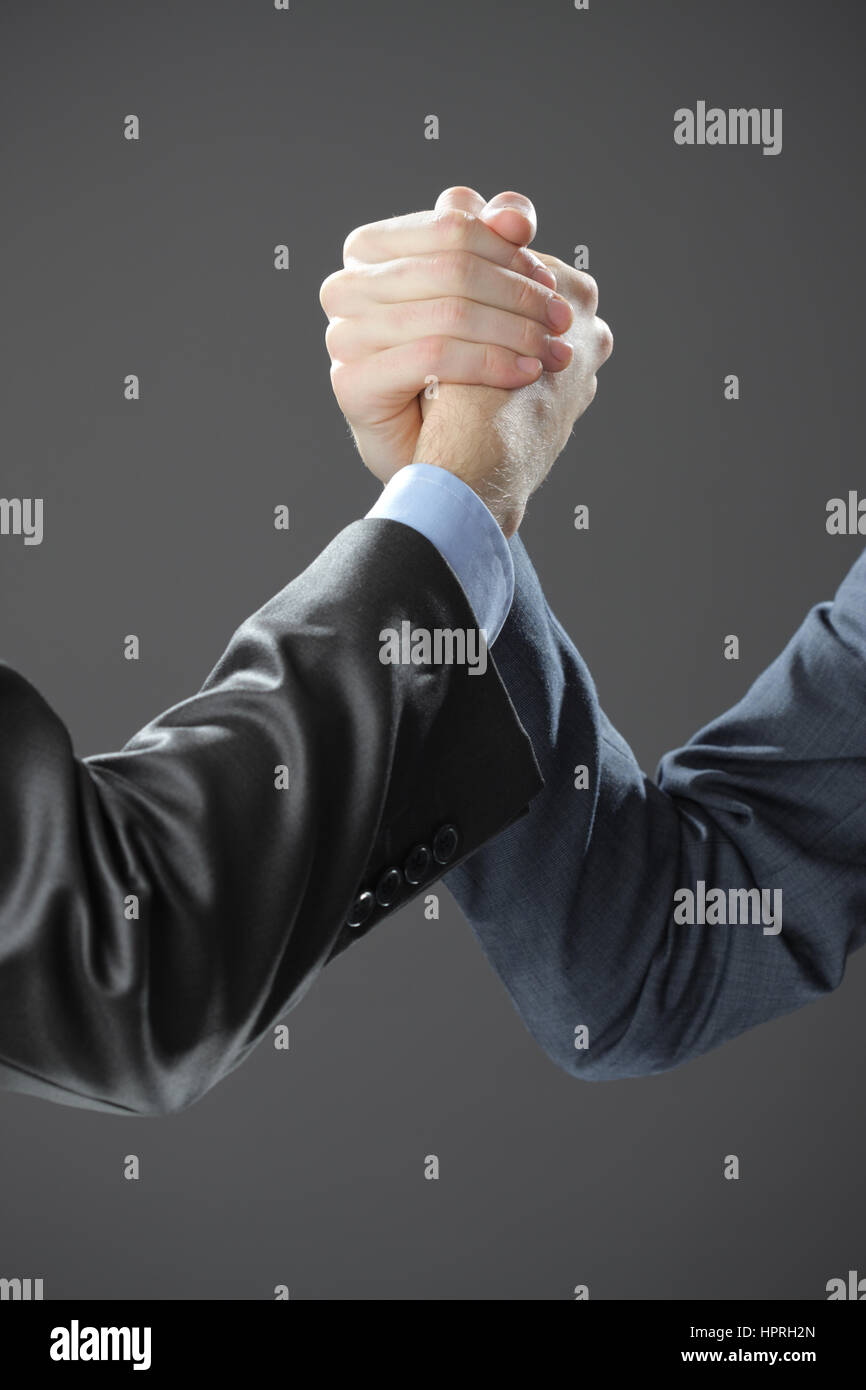 A handclasp between two businessmen, close up Stock Photo - Alamy