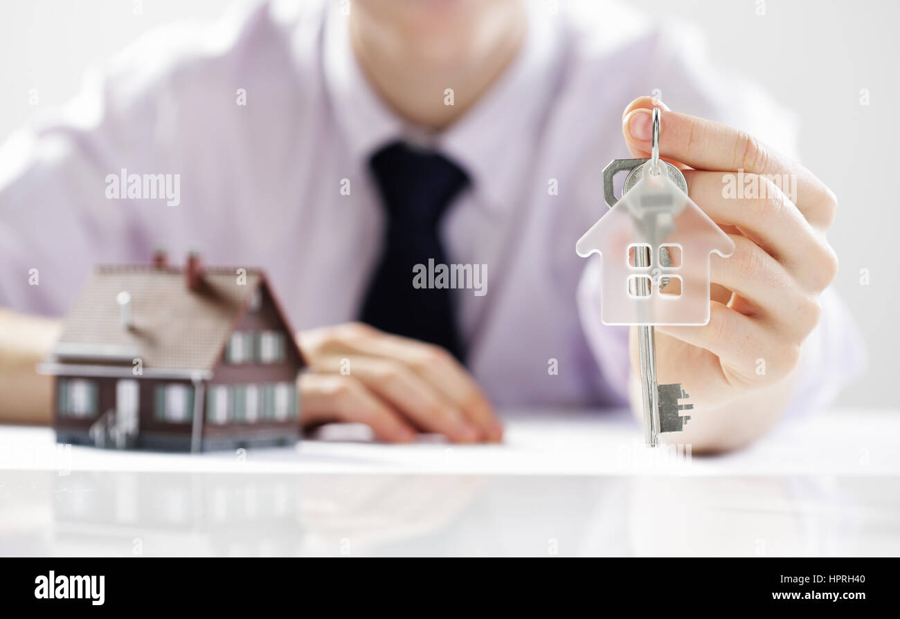 Young businessman giving house keys Stock Photo - Alamy