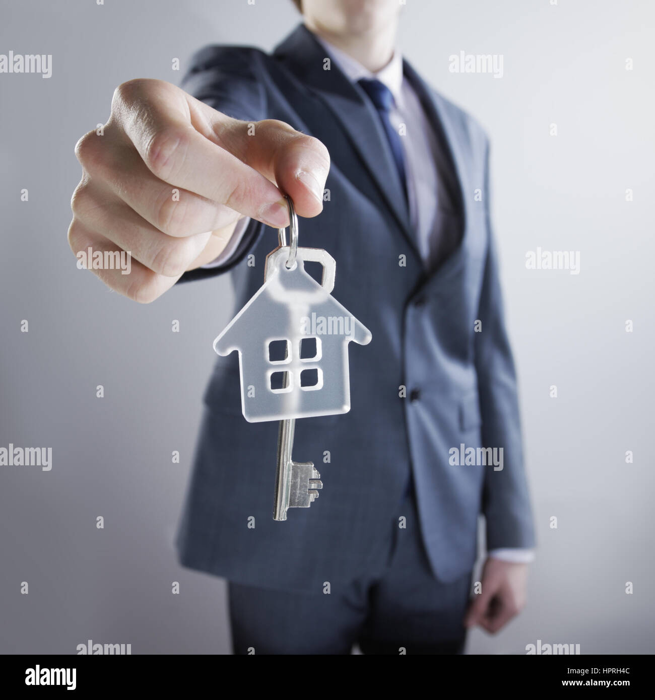 Young businessman giving house keys Stock Photo - Alamy