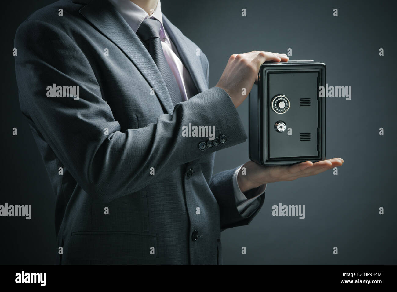 Businessman protecting his savings in the safe Stock Photo - Alamy