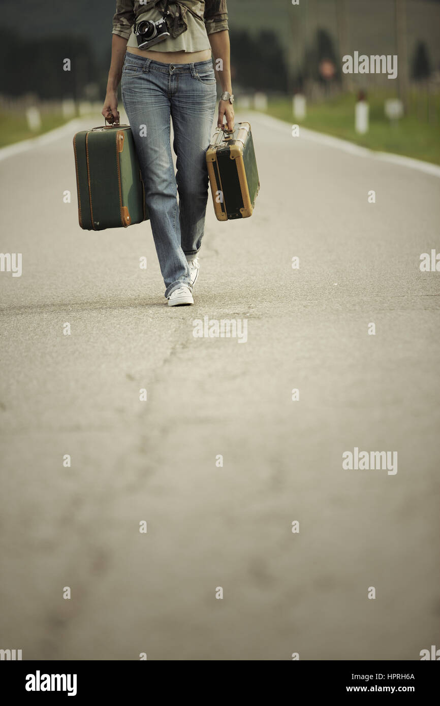 Young woman runaway walks away road. Copy space Stock Photo - Alamy