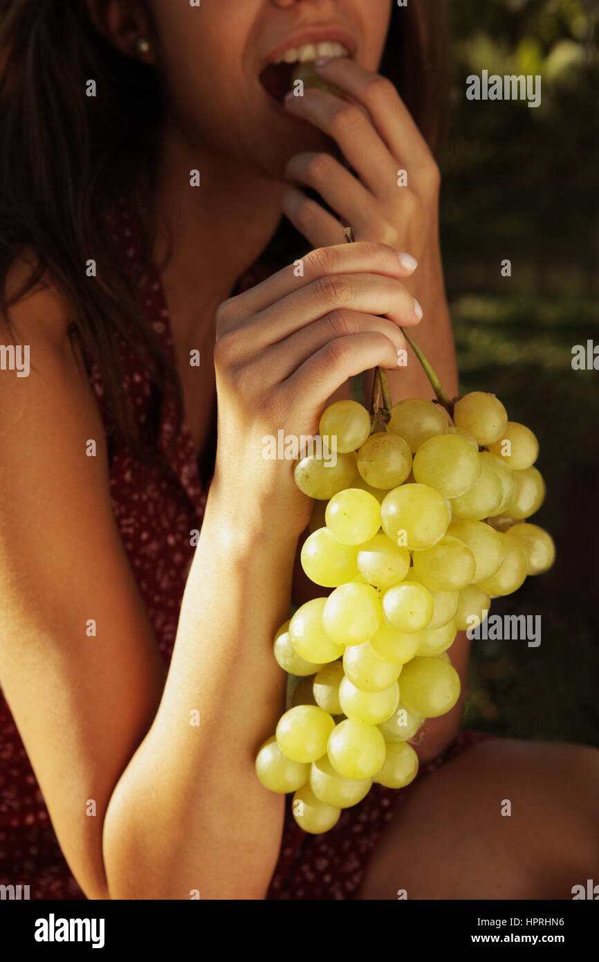 Woman Eating Grapes Stock Photo - Alamy