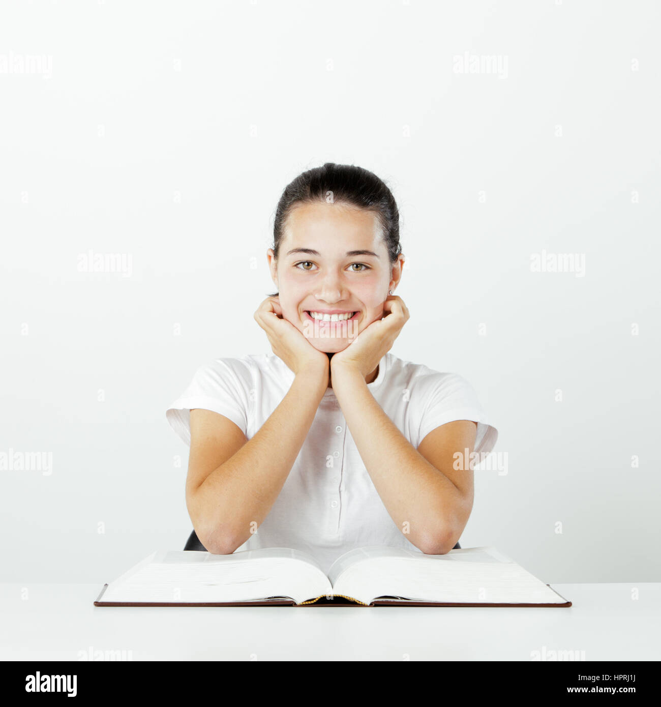 Young smiling girl with open book Stock Photo - Alamy