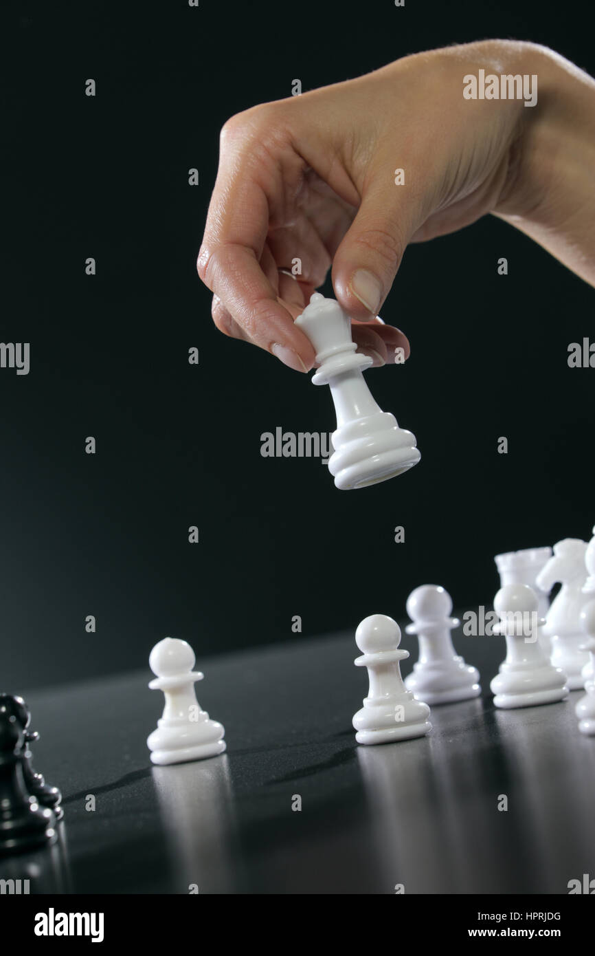 Female hand moving the queen in a chess game Stock Photo - Alamy