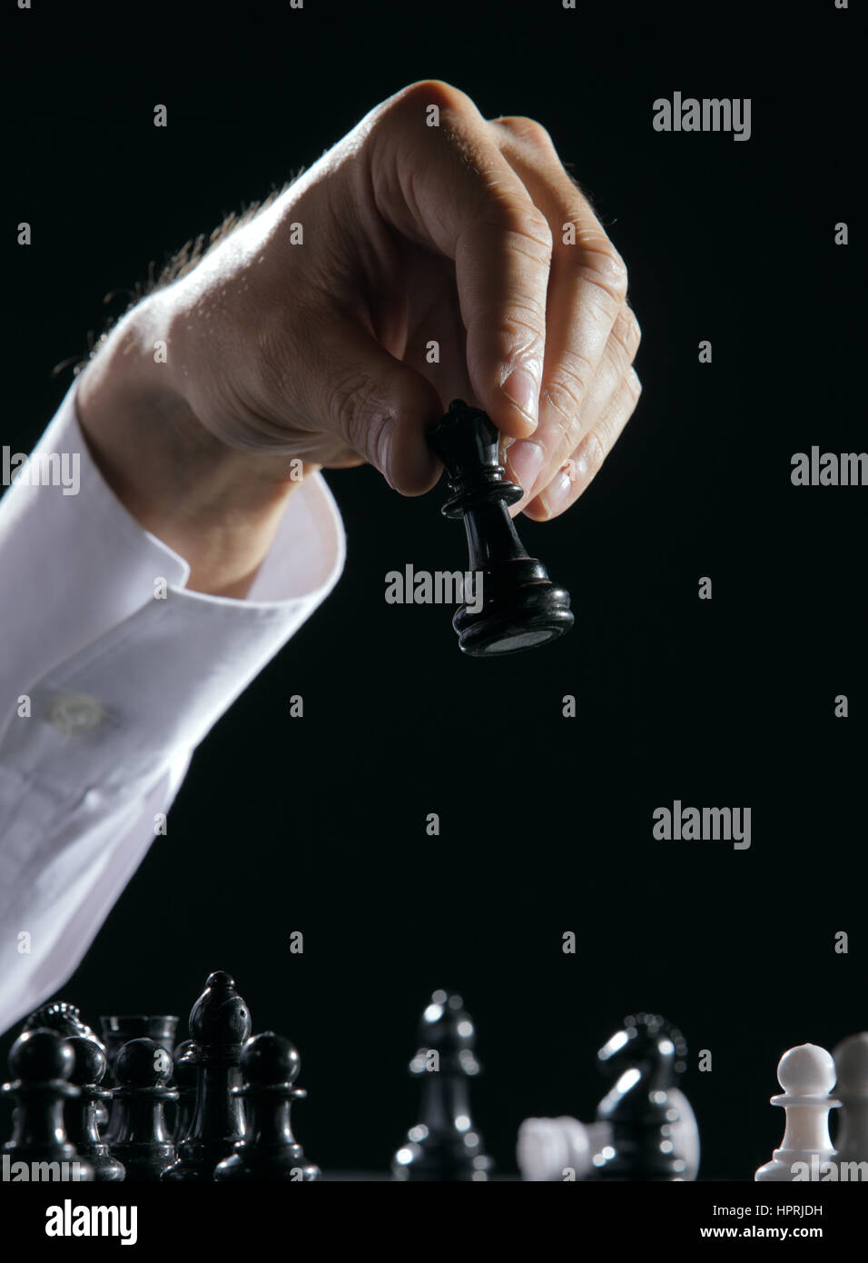 Male hand moving the queen in a chess game Stock Photo - Alamy