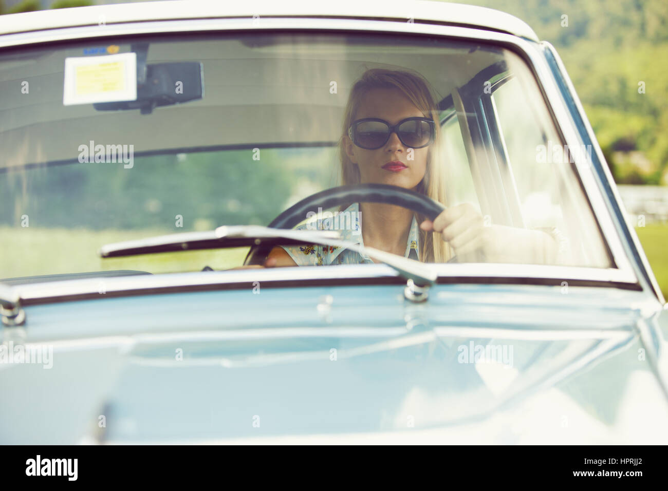 Young woman driving vintage car Stock Photo - Alamy