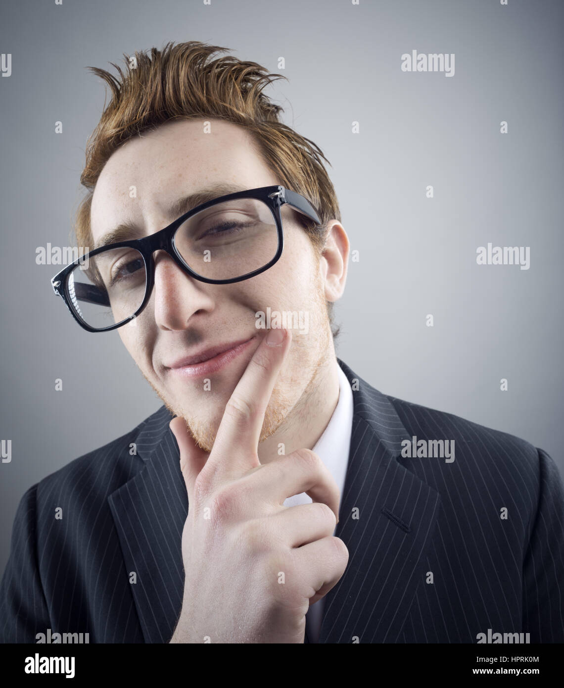 Portrait of a young Nerd businessman thinking Stock Photo - Alamy