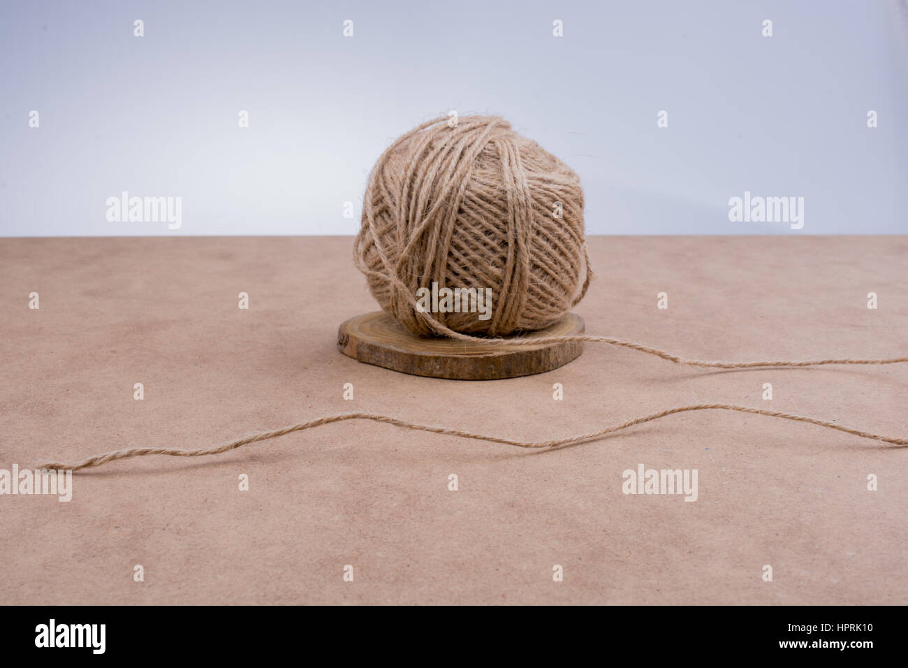 Roll of brown color linen string on brown background Stock Photo - Alamy