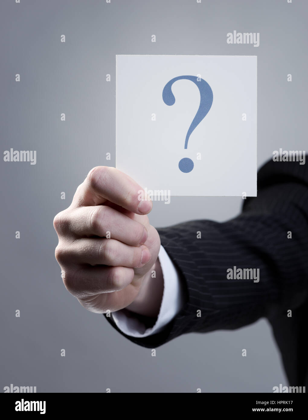 Businessman hand holding a question mark sign, close up Stock Photo - Alamy