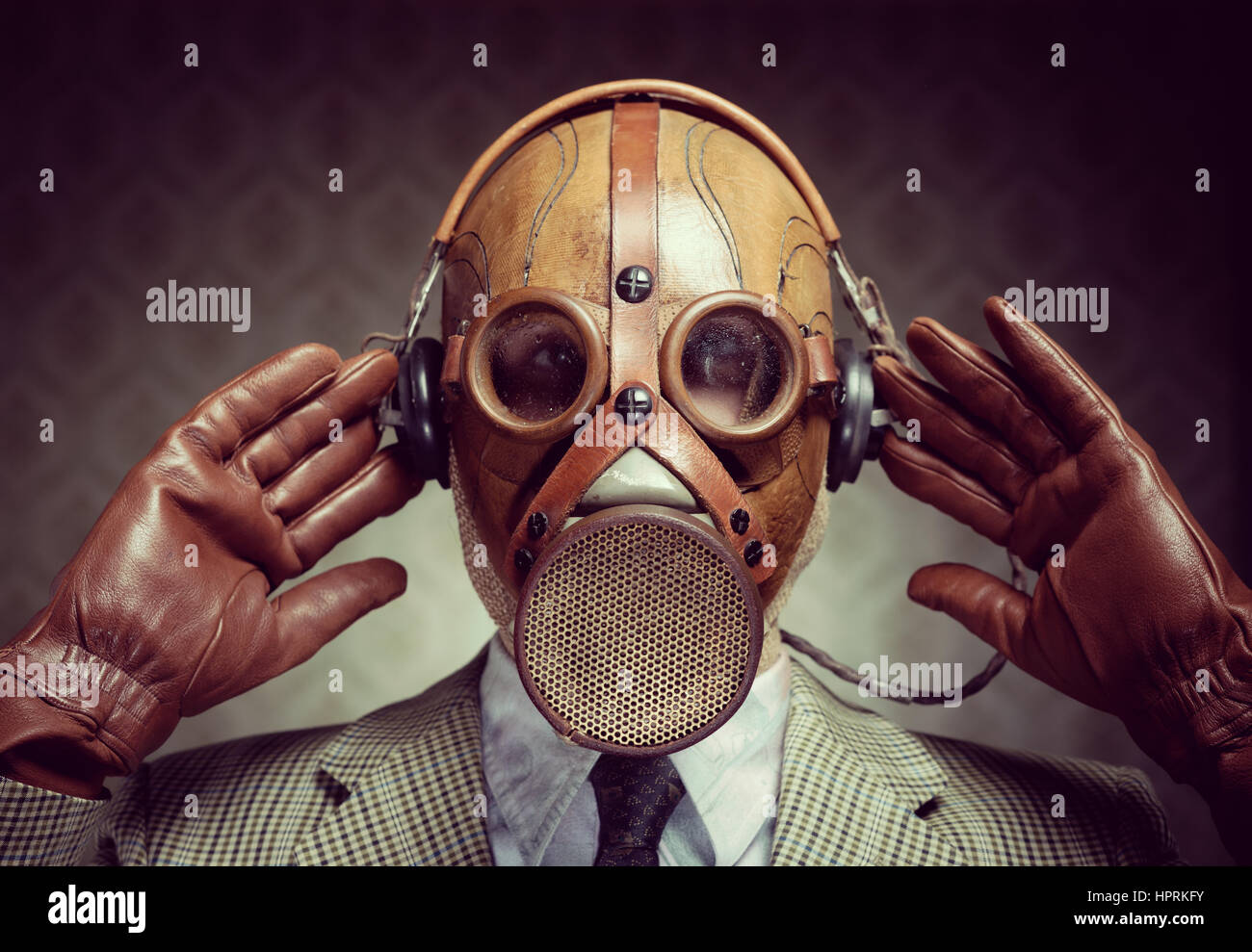 Man wearing vintage gas mask and headphones listening to music Stock ...