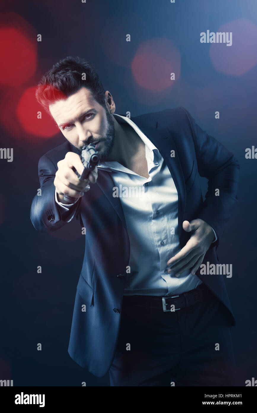 Cool aggressive man in shirt and jacket pointing a gun Stock Photo - Alamy