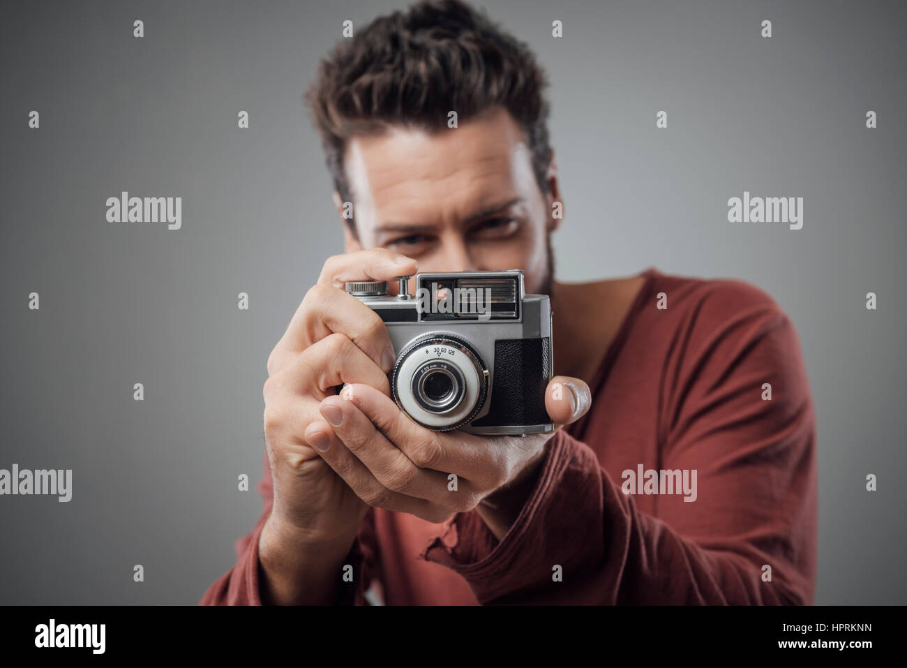 Young man taking pictures with an old vintage camera Stock Photo - Alamy