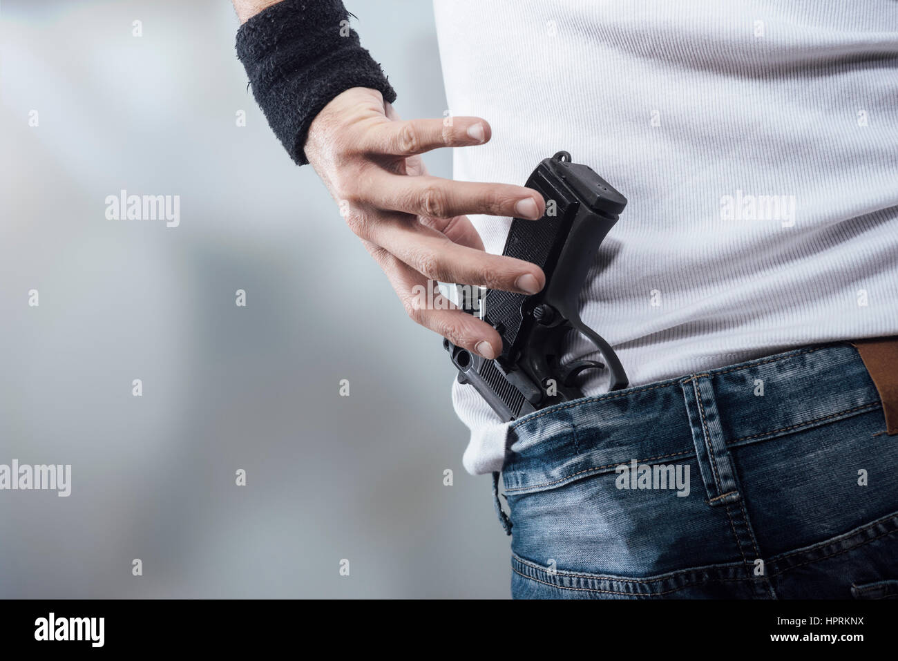 Man grabbing quickly a pistol, hands close up Stock Photo - Alamy