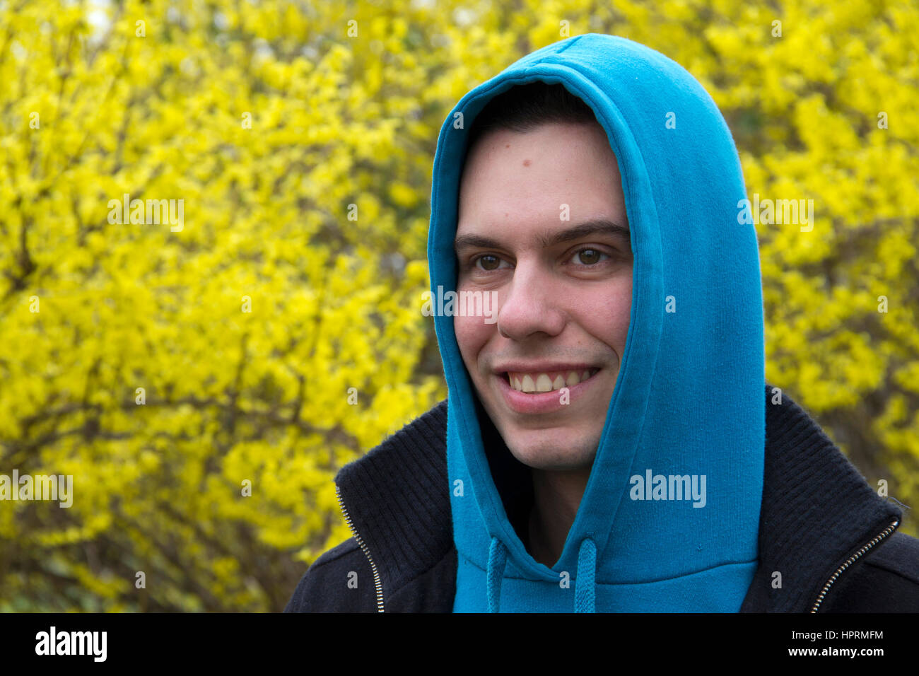 young man with a blue hood Stock Photo - Alamy