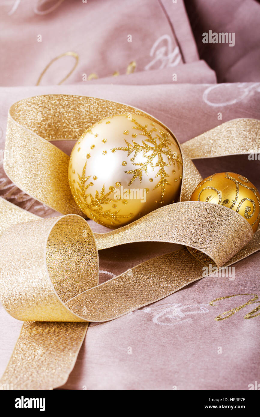 Festive gold Christmas decorations on a fabric background Stock Photo ...