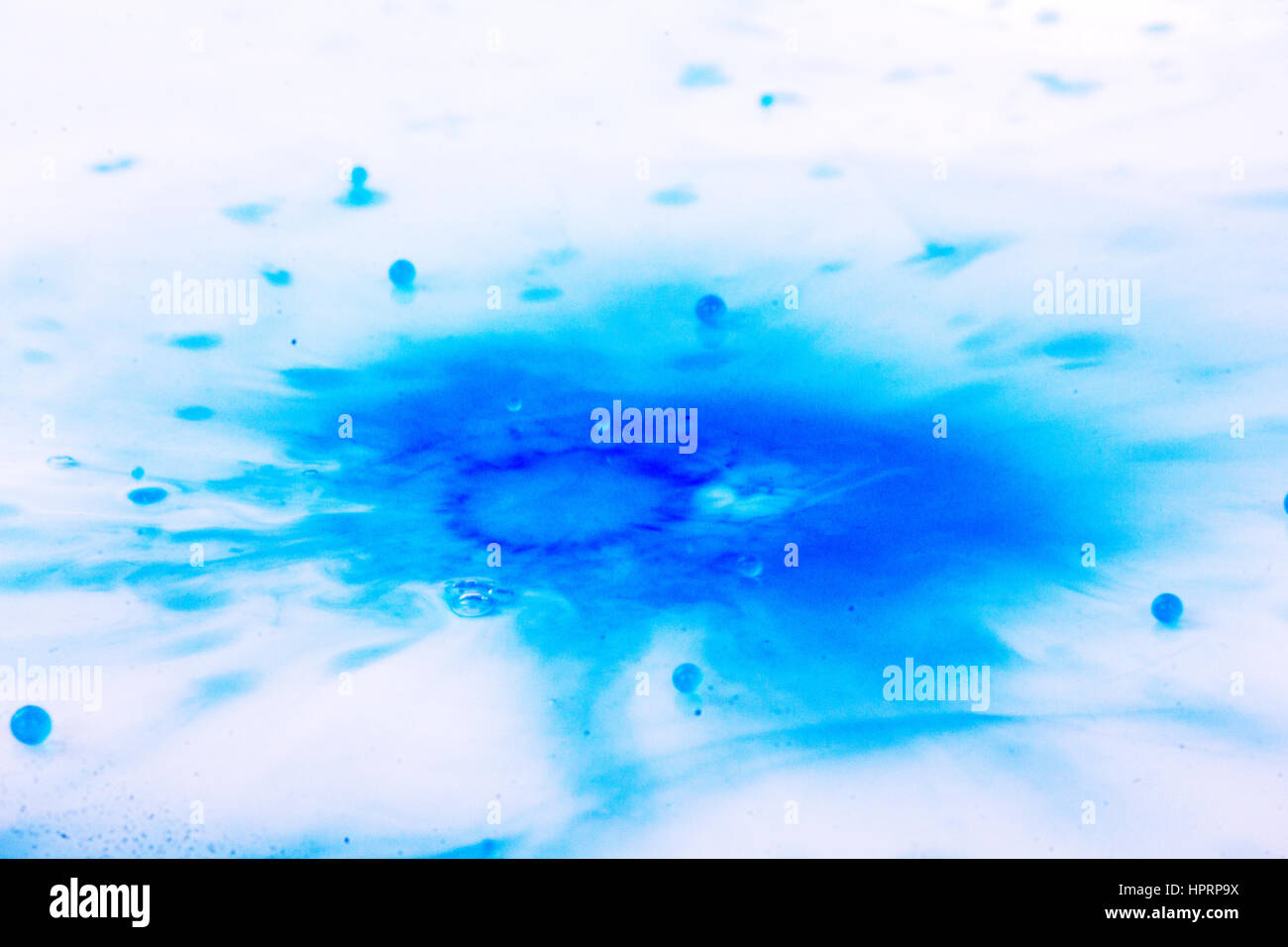Colorful paint drop splashing on black a background Stock Photo - Alamy
